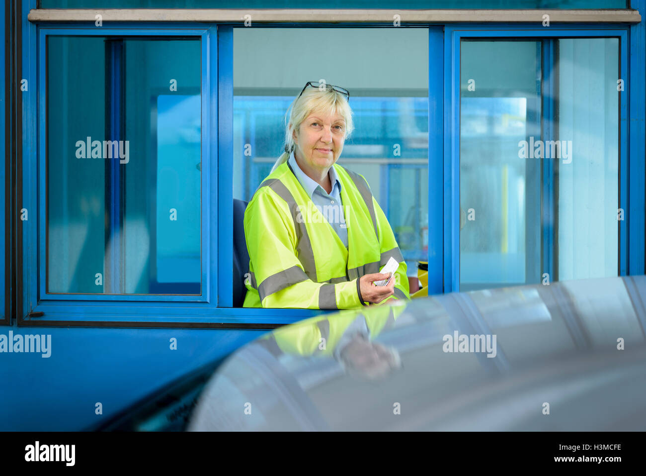 Portrait of female toll collector at toll booth on bridge Stock Photo ...