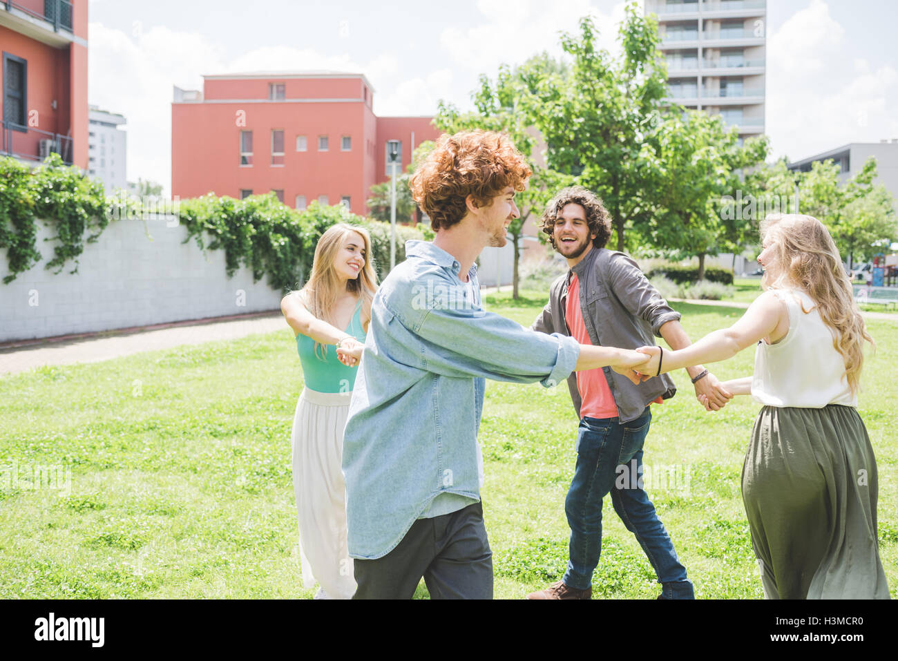 Friends circle dancing in park hi-res stock photography and images - Alamy