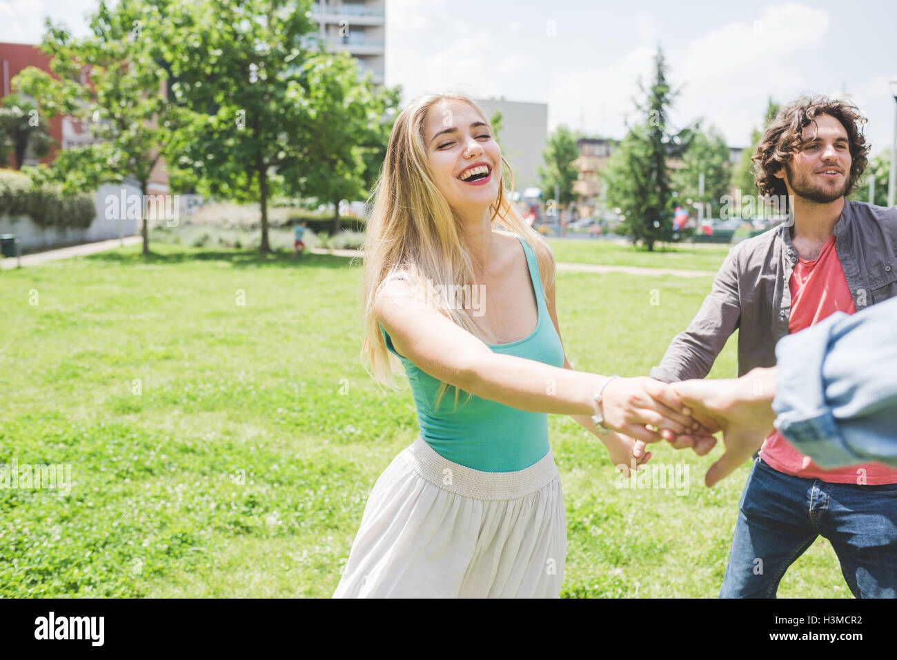 Friends circle dancing in park hi-res stock photography and images - Alamy