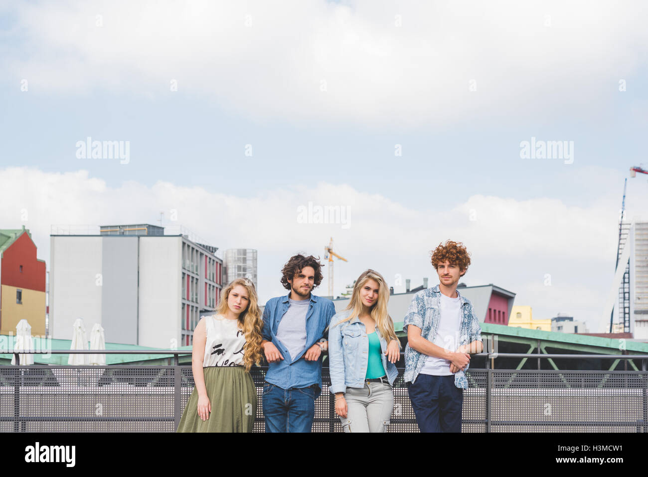 Woman leaning against rail hi-res stock photography and images - Alamy