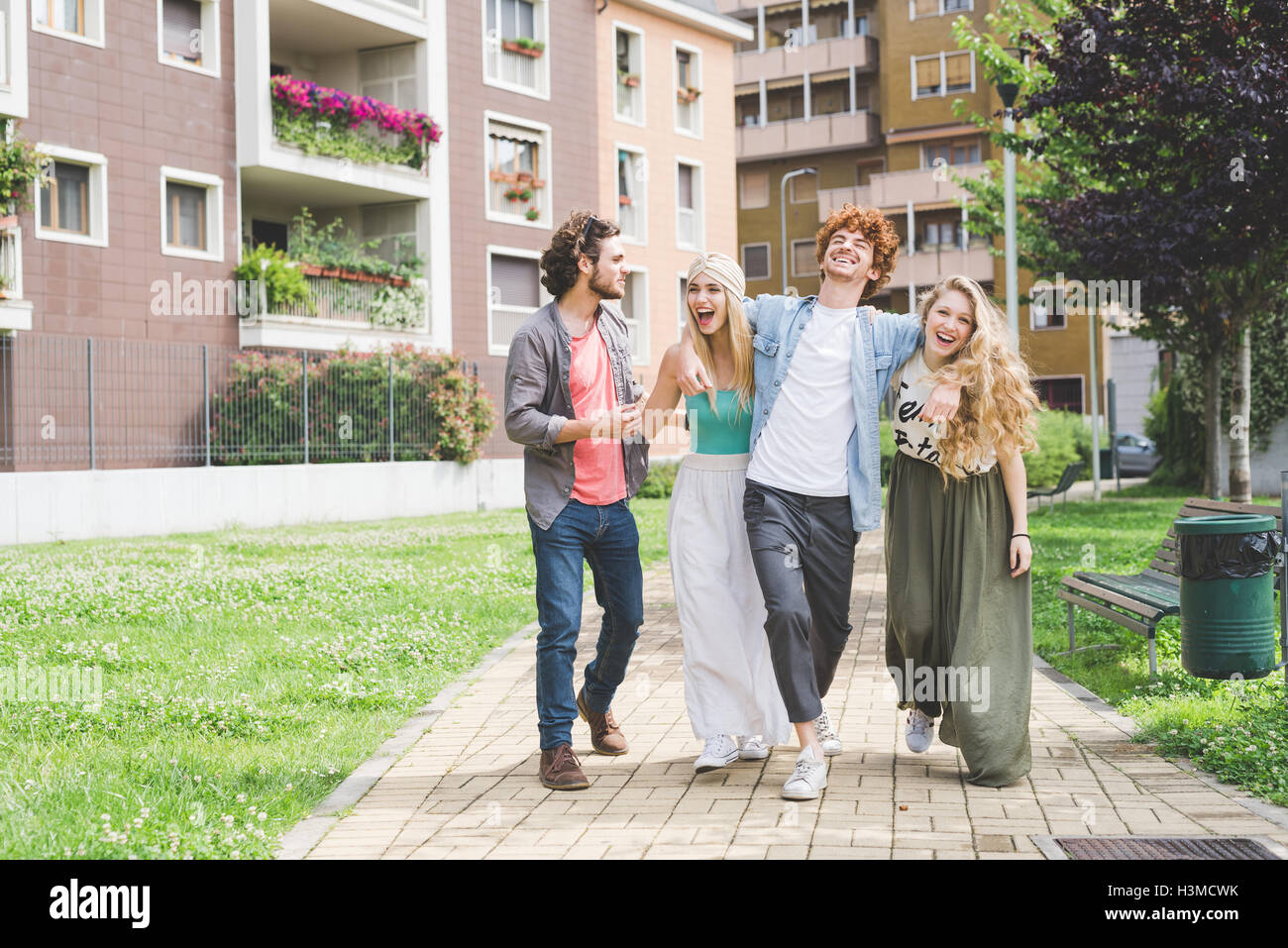 Friends walking in park Stock Photo - Alamy