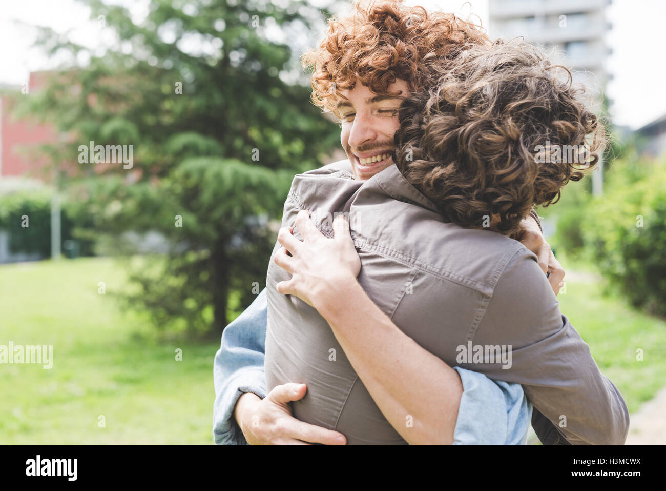 Two men hugging friends hi-res stock photography and images - Alamy