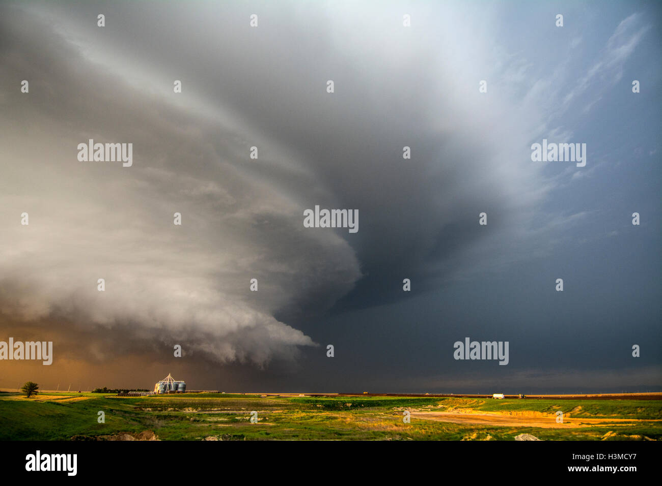 A tornado-producing supercell thunderstorm spinning over ranch land at ...