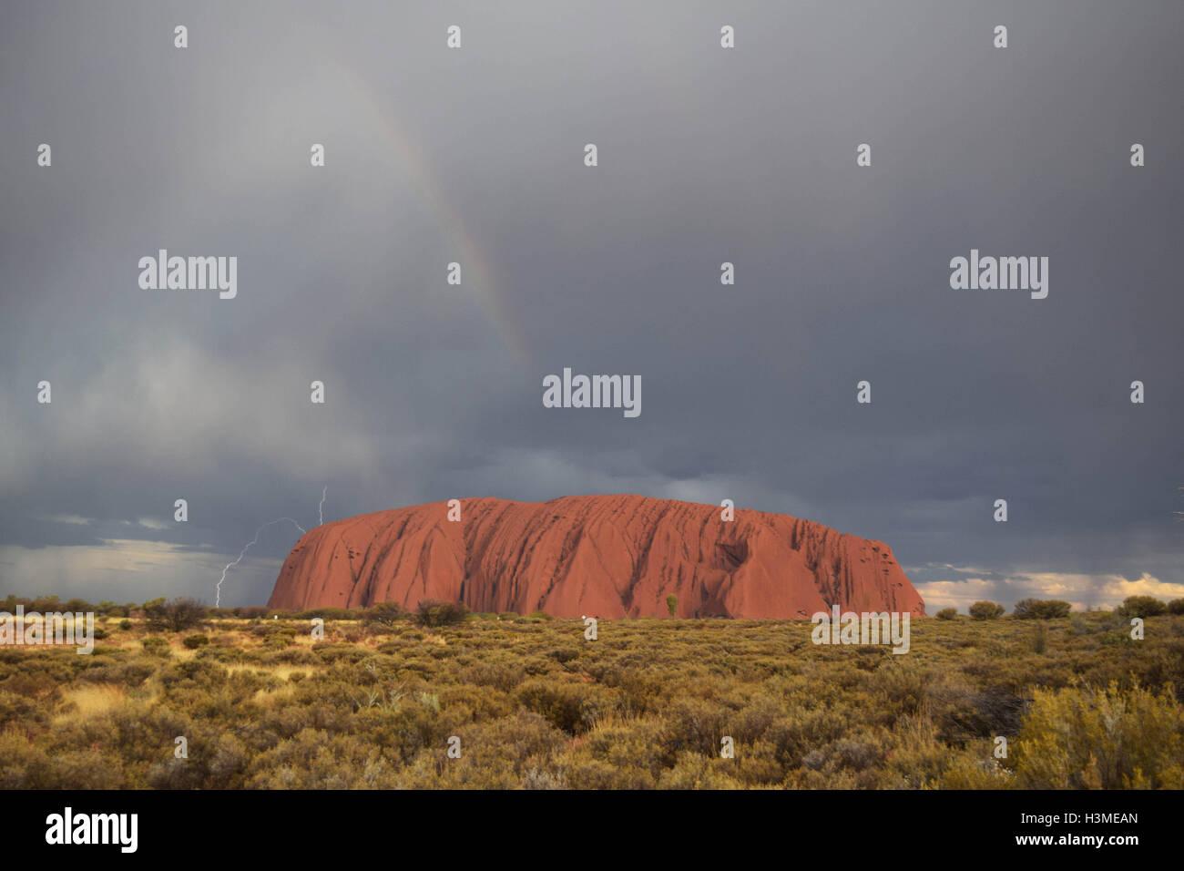 Uluru with Rainbow and Lightning Stock Photo - Alamy
