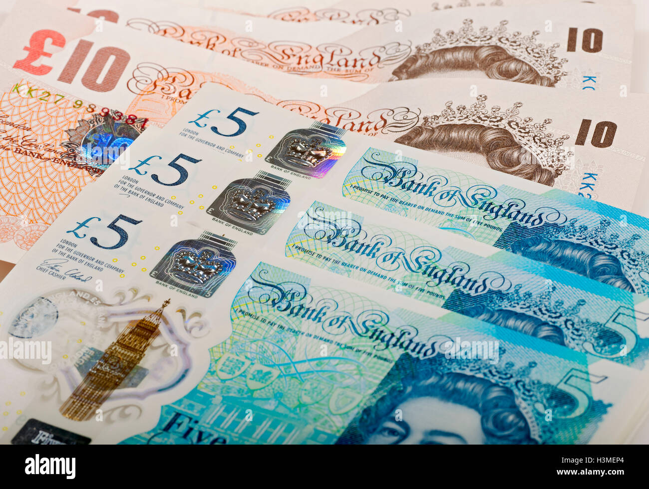 Close up of polymer five pound £5 £10 notes and paper ten pound note ...