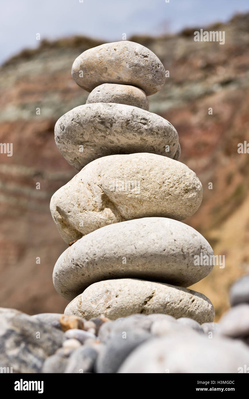 Stones balanced on each other to form a tower on the beach at Seaton in ...