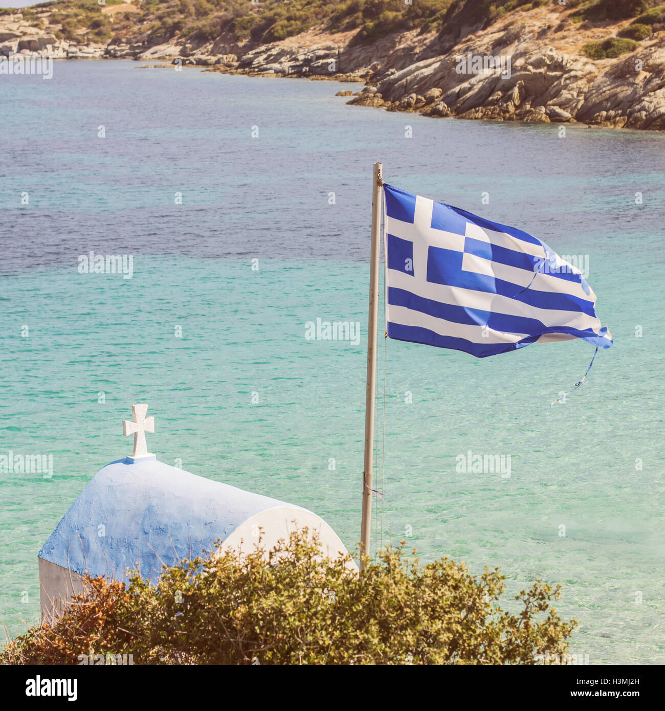 The Greek National Flag over seascape, beautiful turquoise sea , summer ...