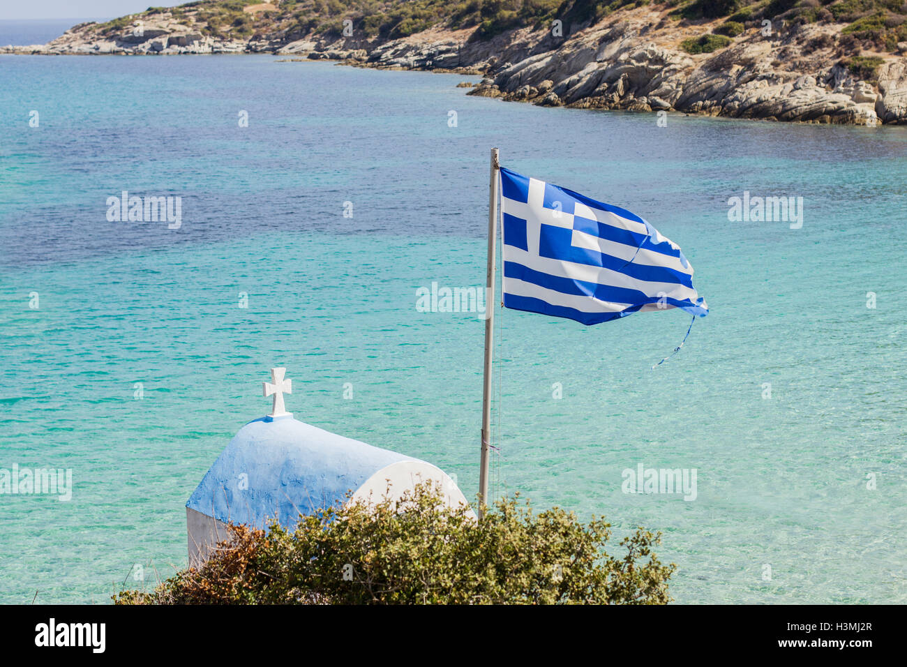 The Greek National Flag over seascape, beautiful turquoise sea , summer ...