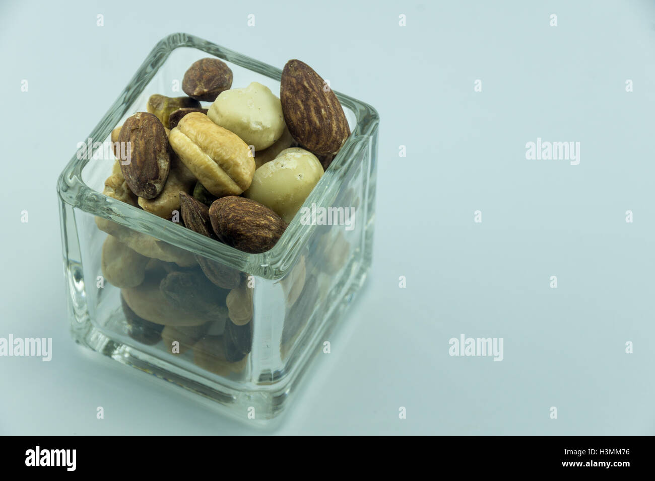 a bunch of assorted nuts in a small glass bowl Stock Photo - Alamy