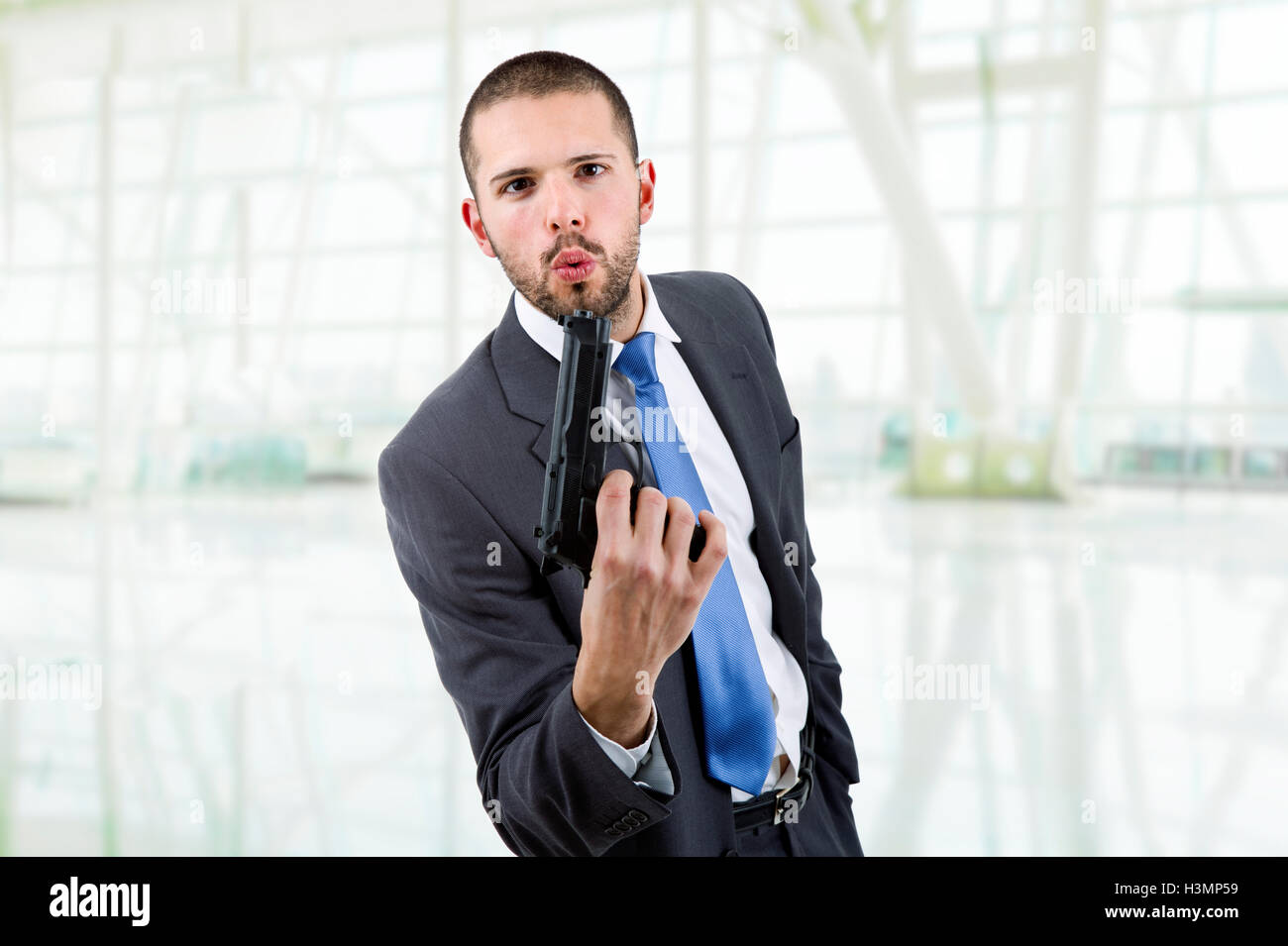 young businessman with a gun, at the office Stock Photo - Alamy