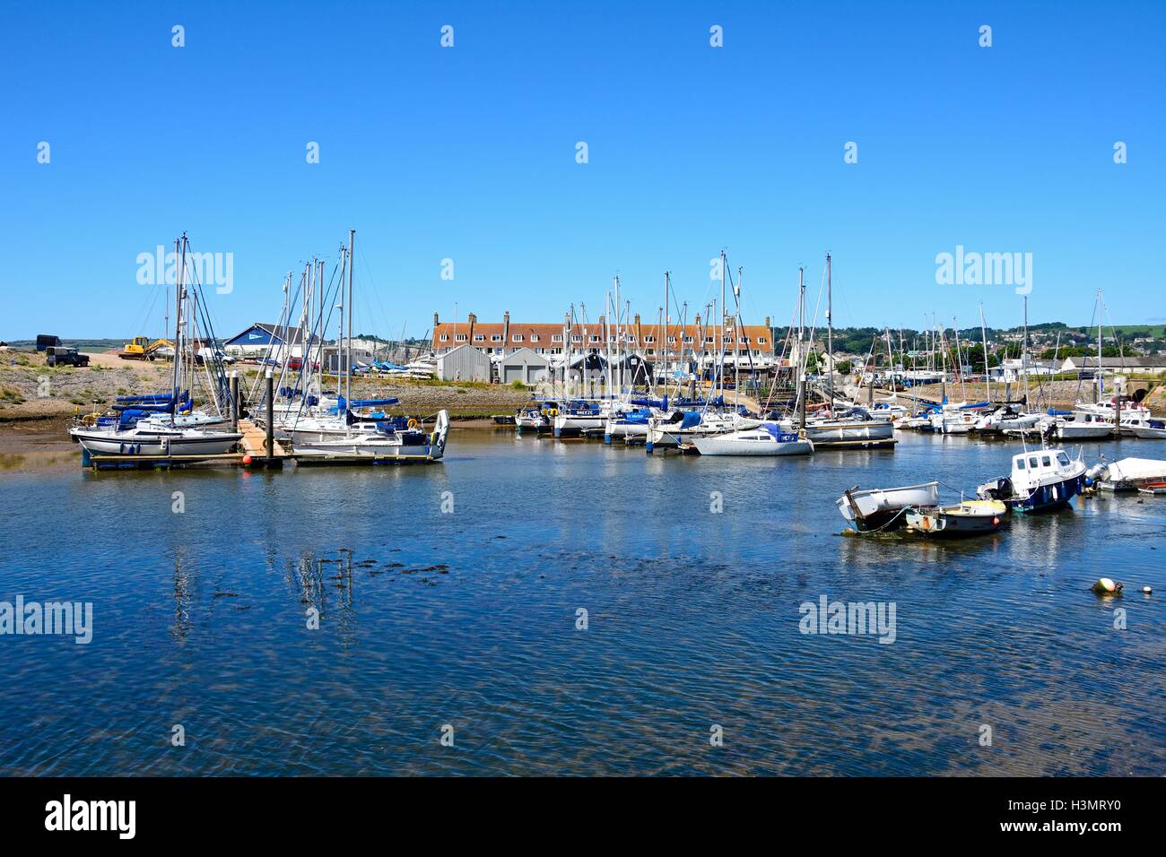Yachts and fishing boats moored in the harbour, Axmouth, Devon, England ...