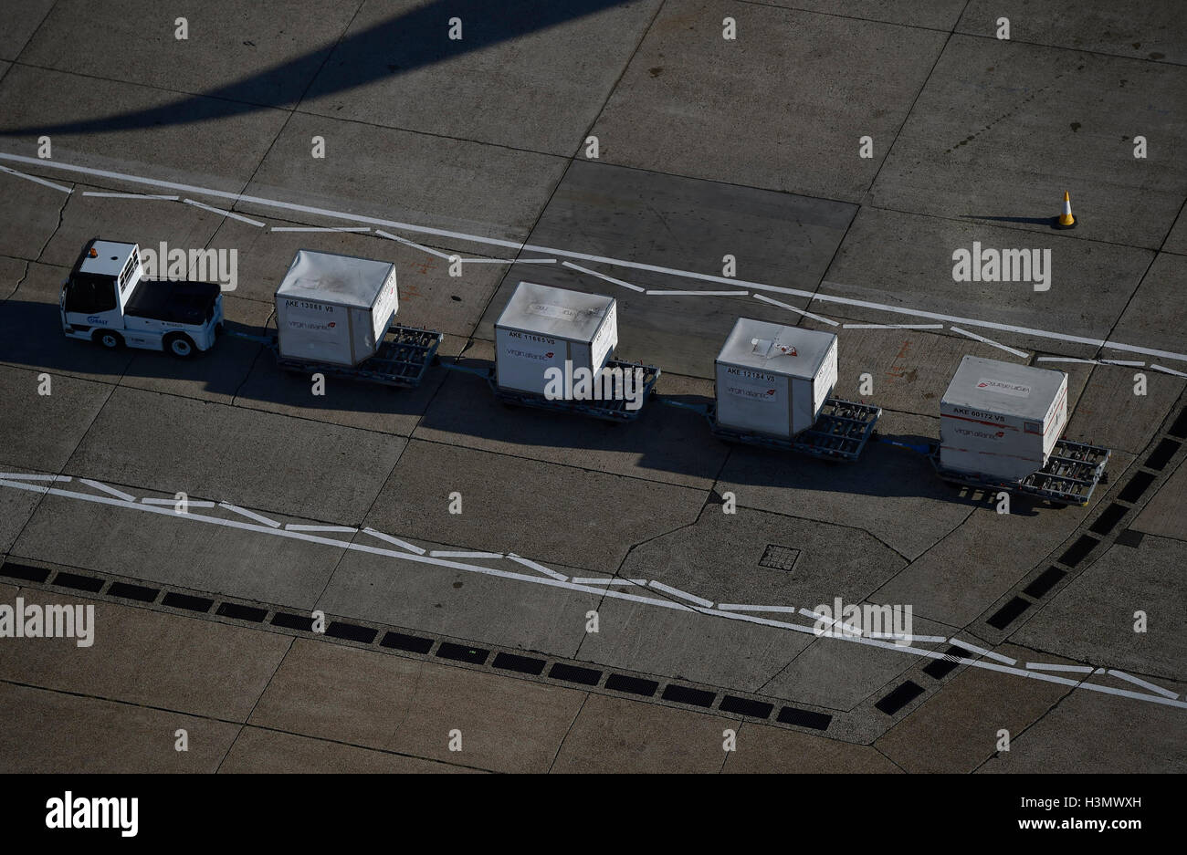 A vehicle crosses the runway at London's Heathrow Airport Stock Photo ...