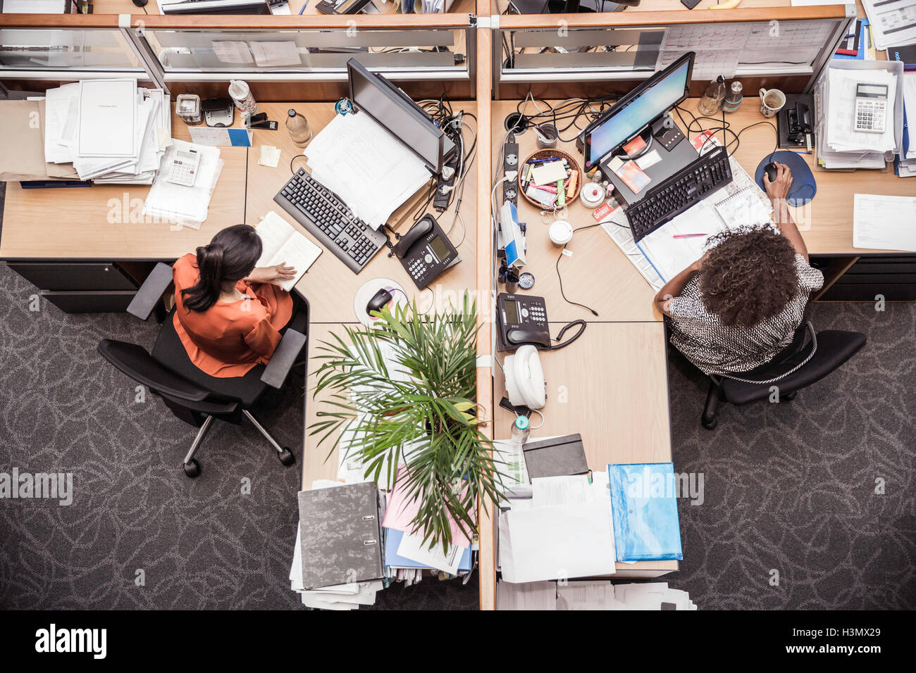 Overhead view of two businesswomen at office desk Stock Photo - Alamy