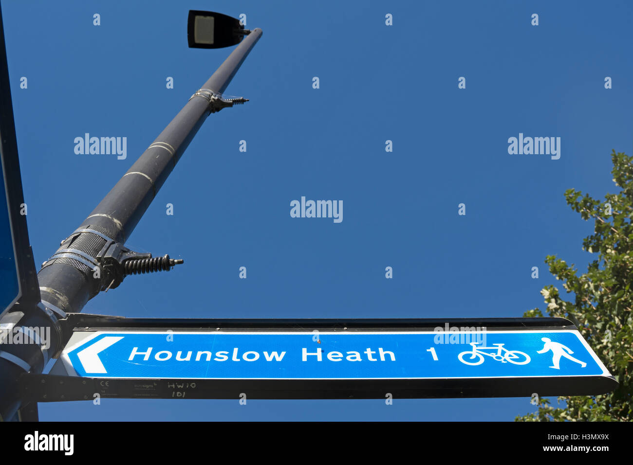 left pointing cycle and walking route and distance sign for hounslow ...