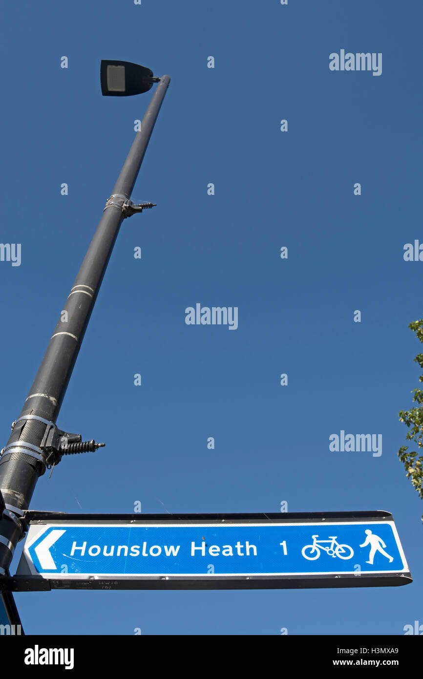 left pointing cycle and walking route and distance sign for hounslow ...