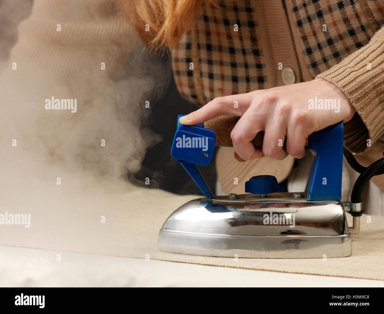 Cropped shot of young female designer steam ironing fabric Stock Photo ...
