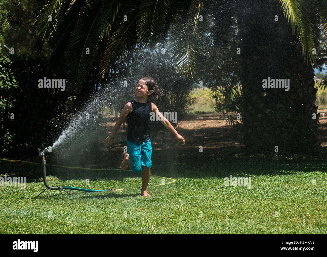 Boy running through water hi-res stock photography and images - Alamy