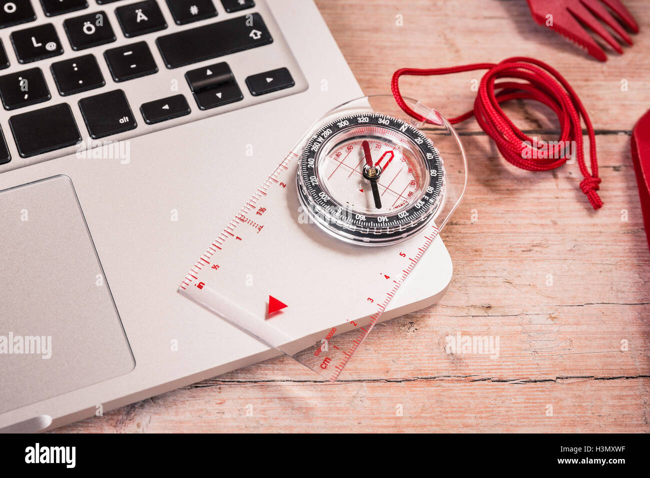 Overhead view of compass and laptop Stock Photo - Alamy
