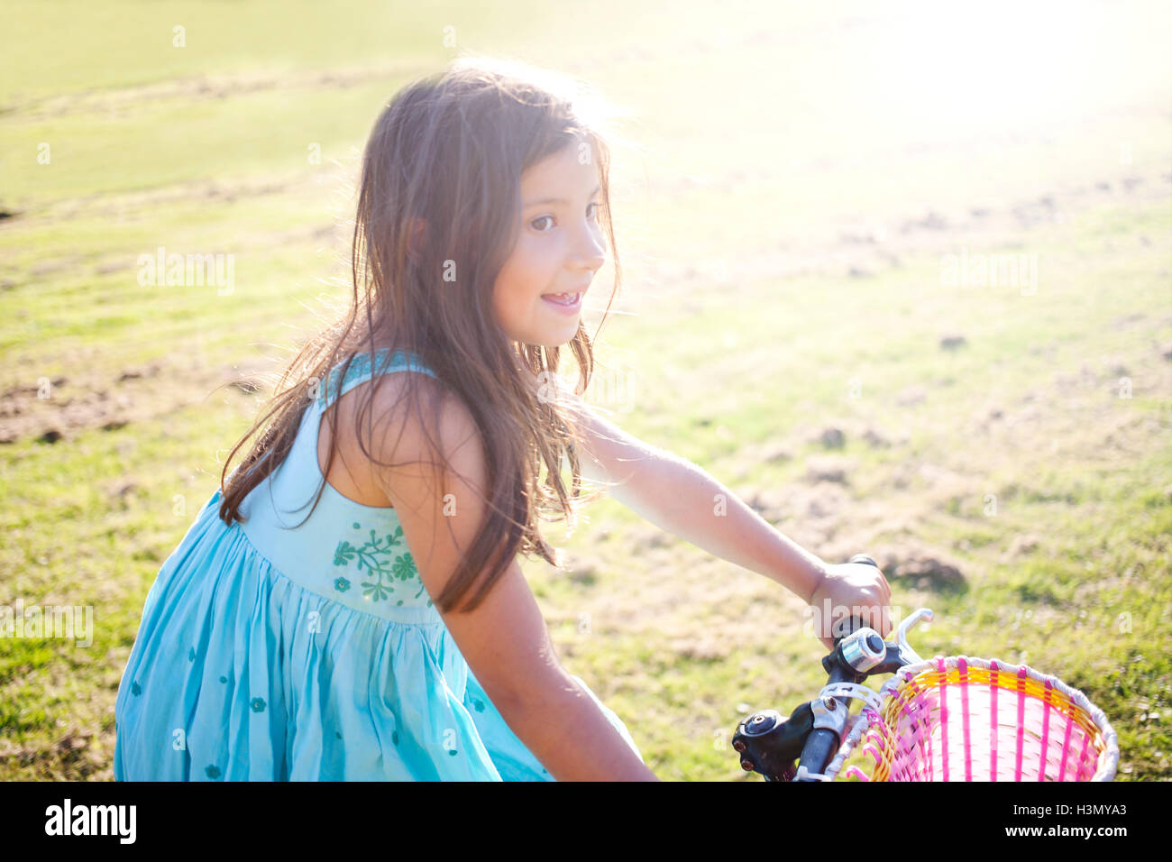Young girl riding bike in summer Stock Photo - Alamy