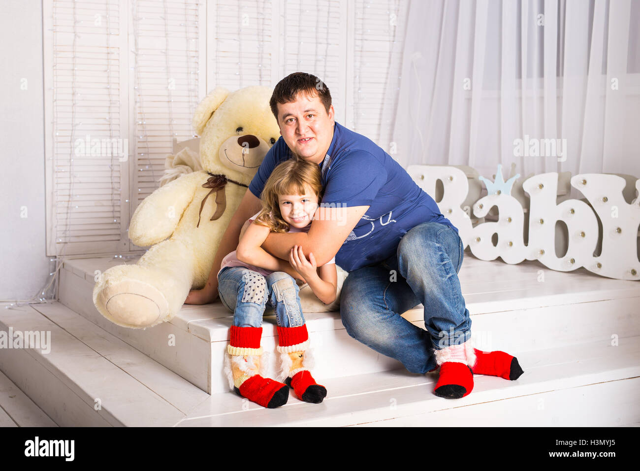 Portrait of father embracing his cute daughter in house Stock Photo - Alamy