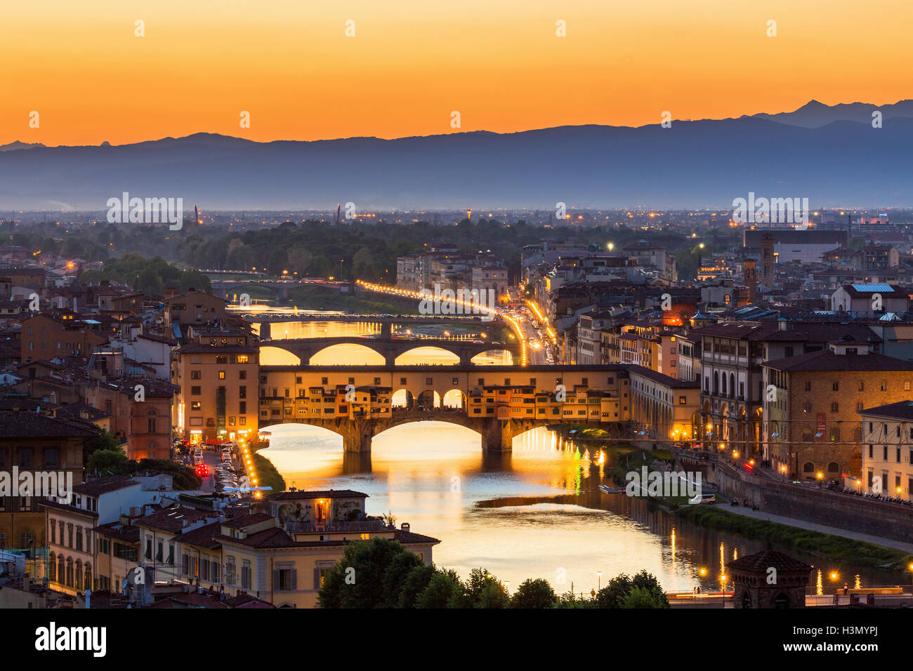 View of Florence at sunset with the Ponte Vecchio bridge over the Arno River Stock Photo - Alamy