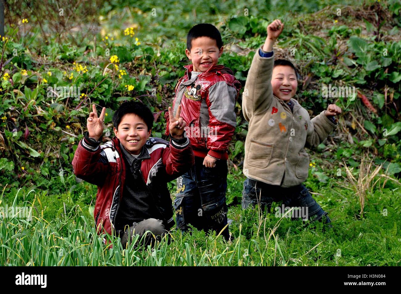 Pengzhou, China - February 5, 2012: Three young Chinese boys playing in ...