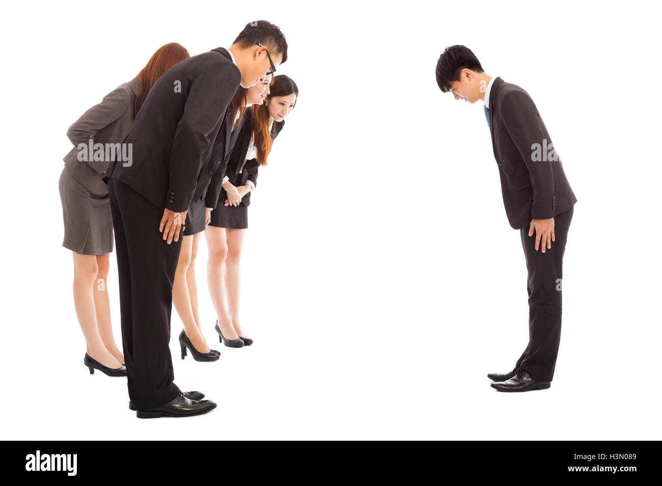 business people and boss with bow and scrape Stock Photo - Alamy