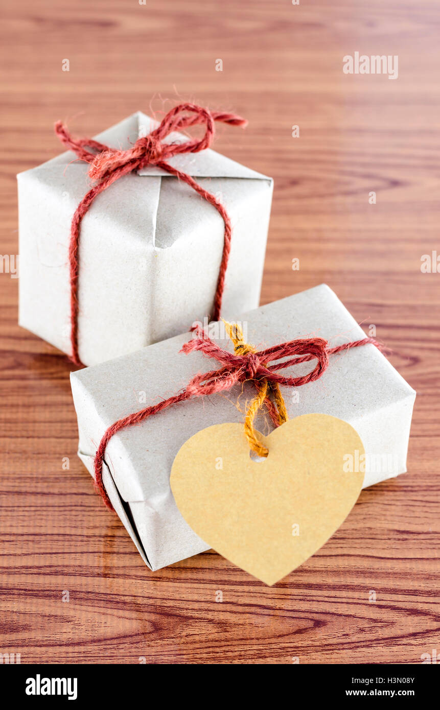 brown gift box with heart tag card Stock Photo - Alamy