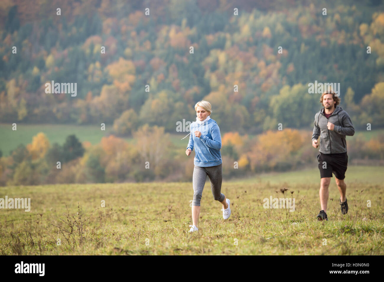 Young couple running in sunny hi-res stock photography and images - Alamy