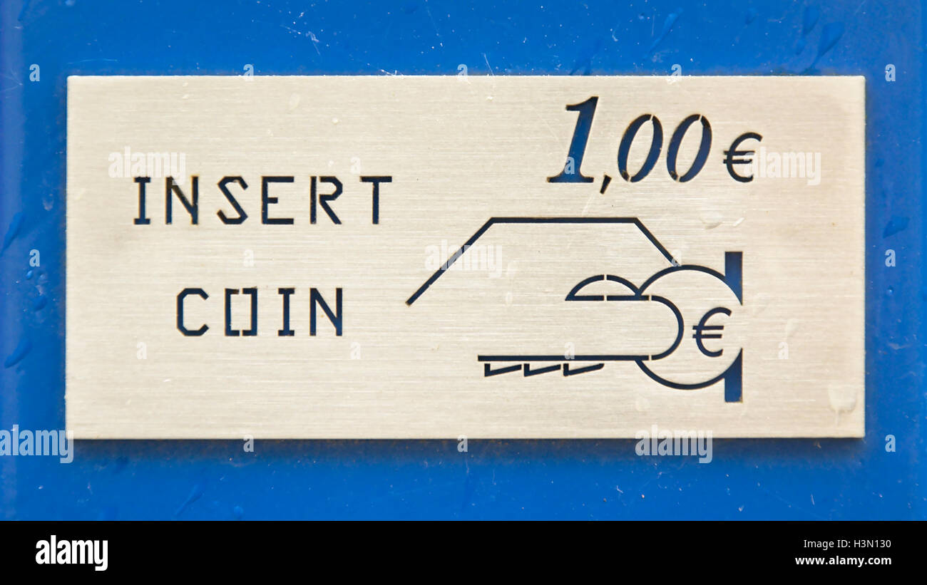 Insert coin sign with hand inserting a one euro coin Stock Photo - Alamy