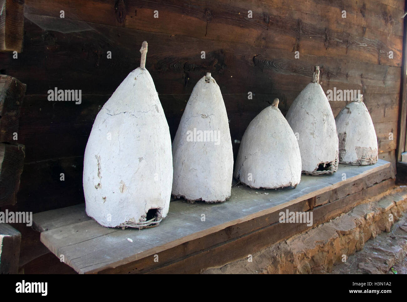 Ancient traditional hives shot on an old country cottage porch at ...