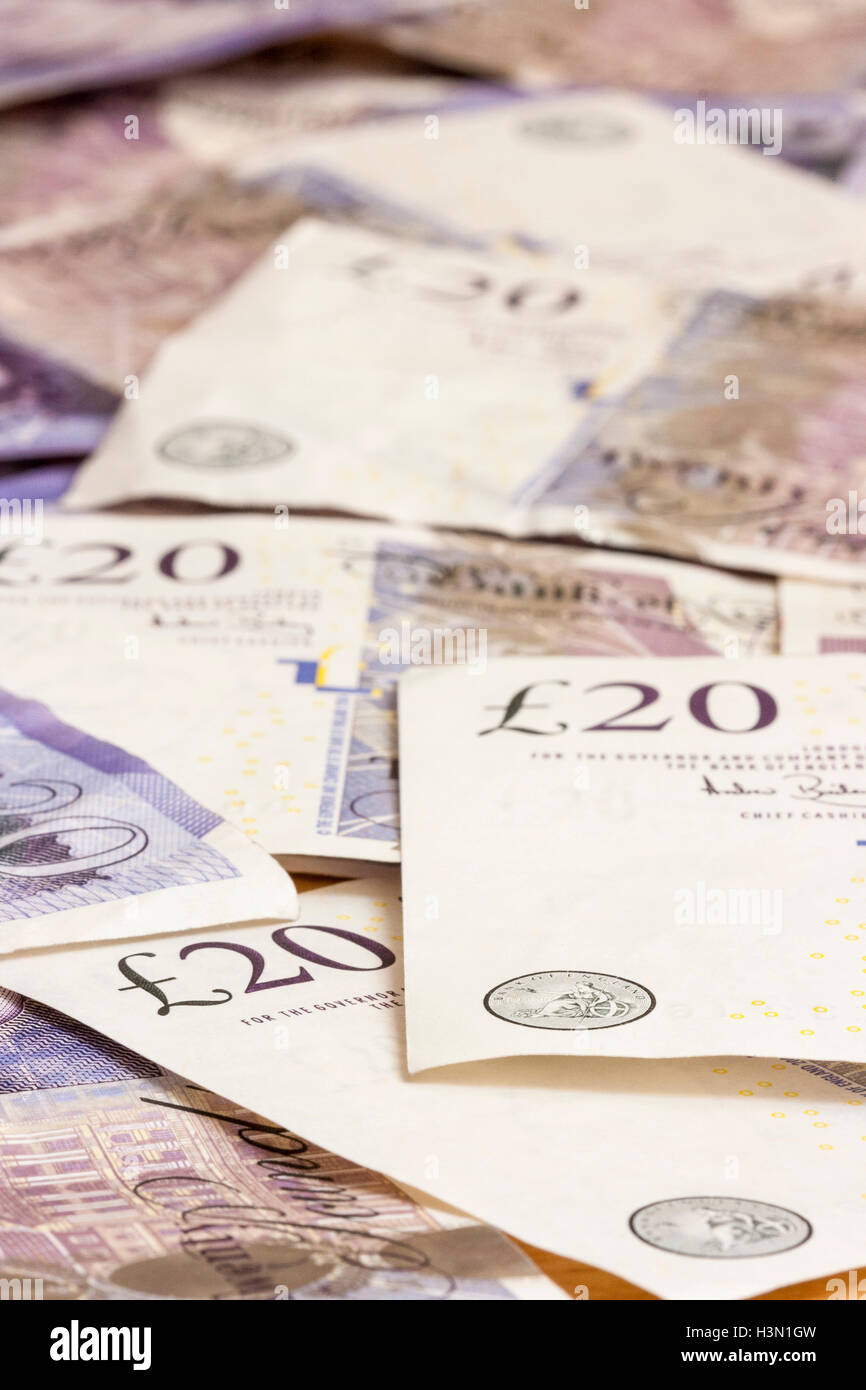 Shallow focus view along British £20, twenty pound notes scattered ...