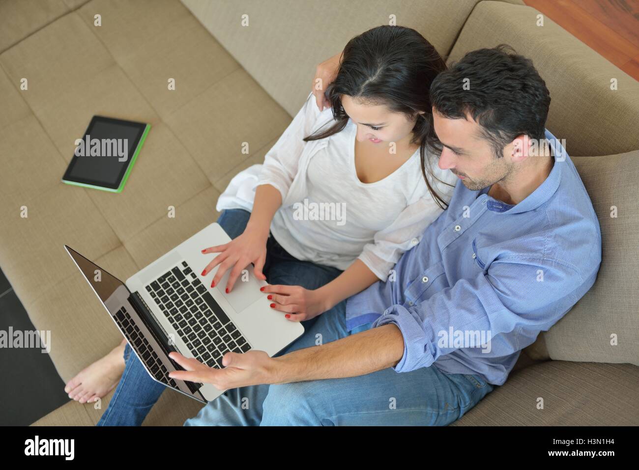 young couple using laptop at home Stock Photo - Alamy