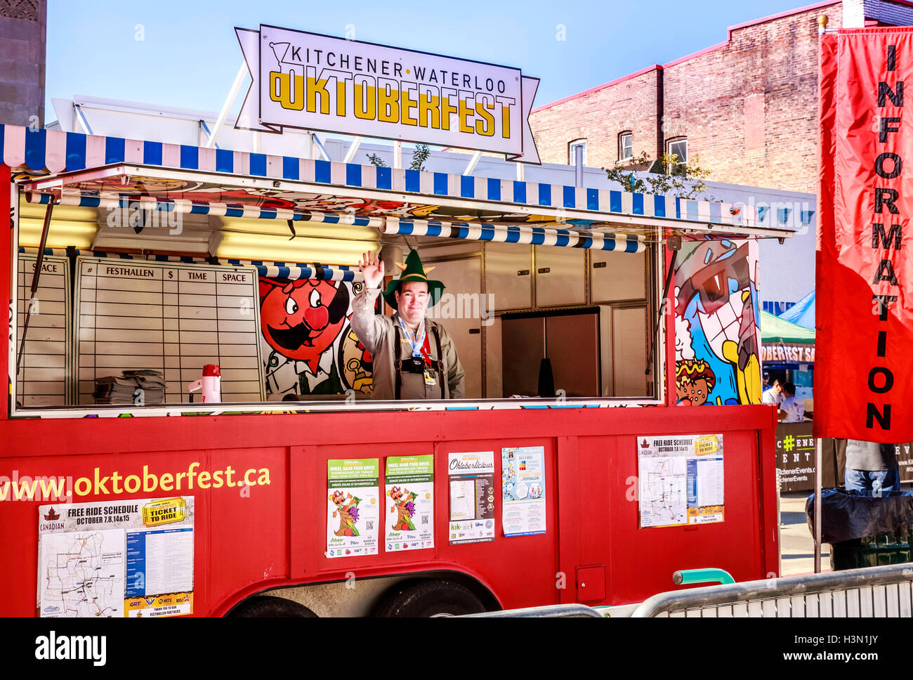 Volunteer waves to camera from Oktoberfest booth, Kitchener Canada ...