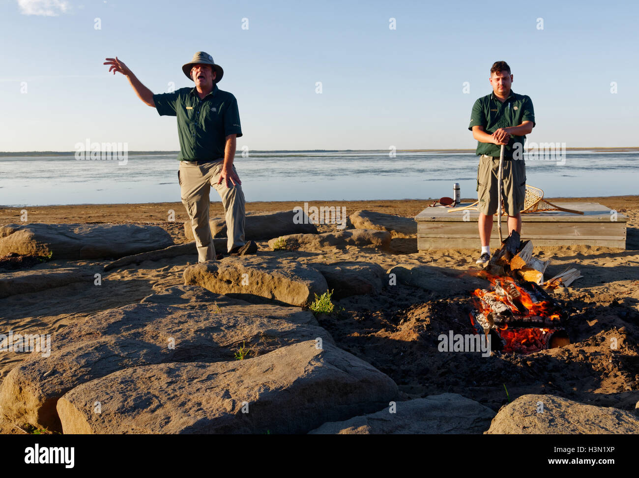 Canadian National Park rangers giving a speech by a campfire in ...