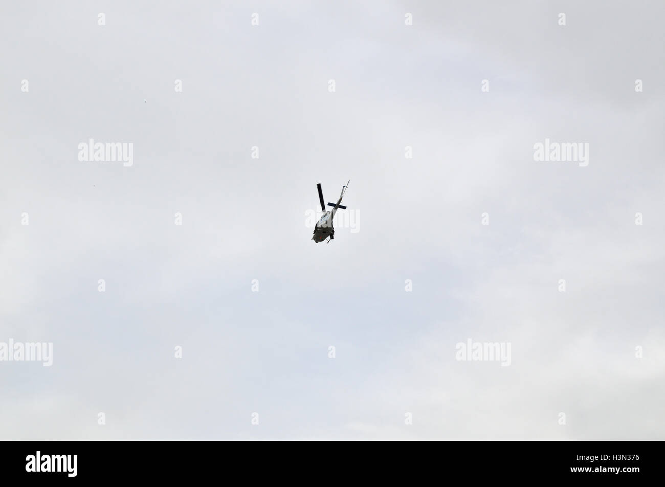 Shot of helicopter from below against grey cloudy sky Stock Photo - Alamy