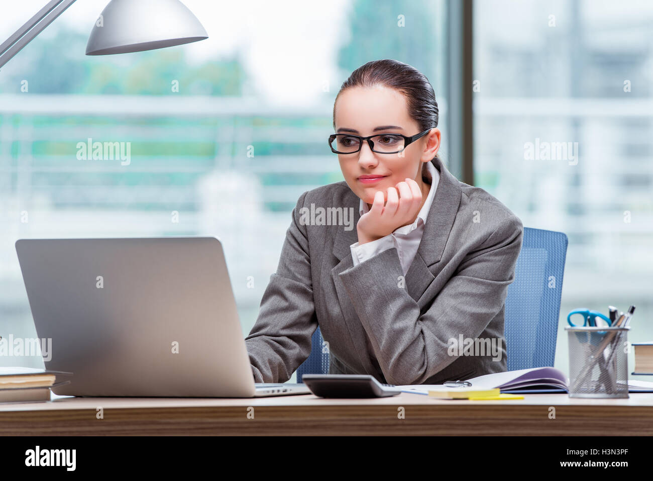 Young assistant working in the office Stock Photo - Alamy