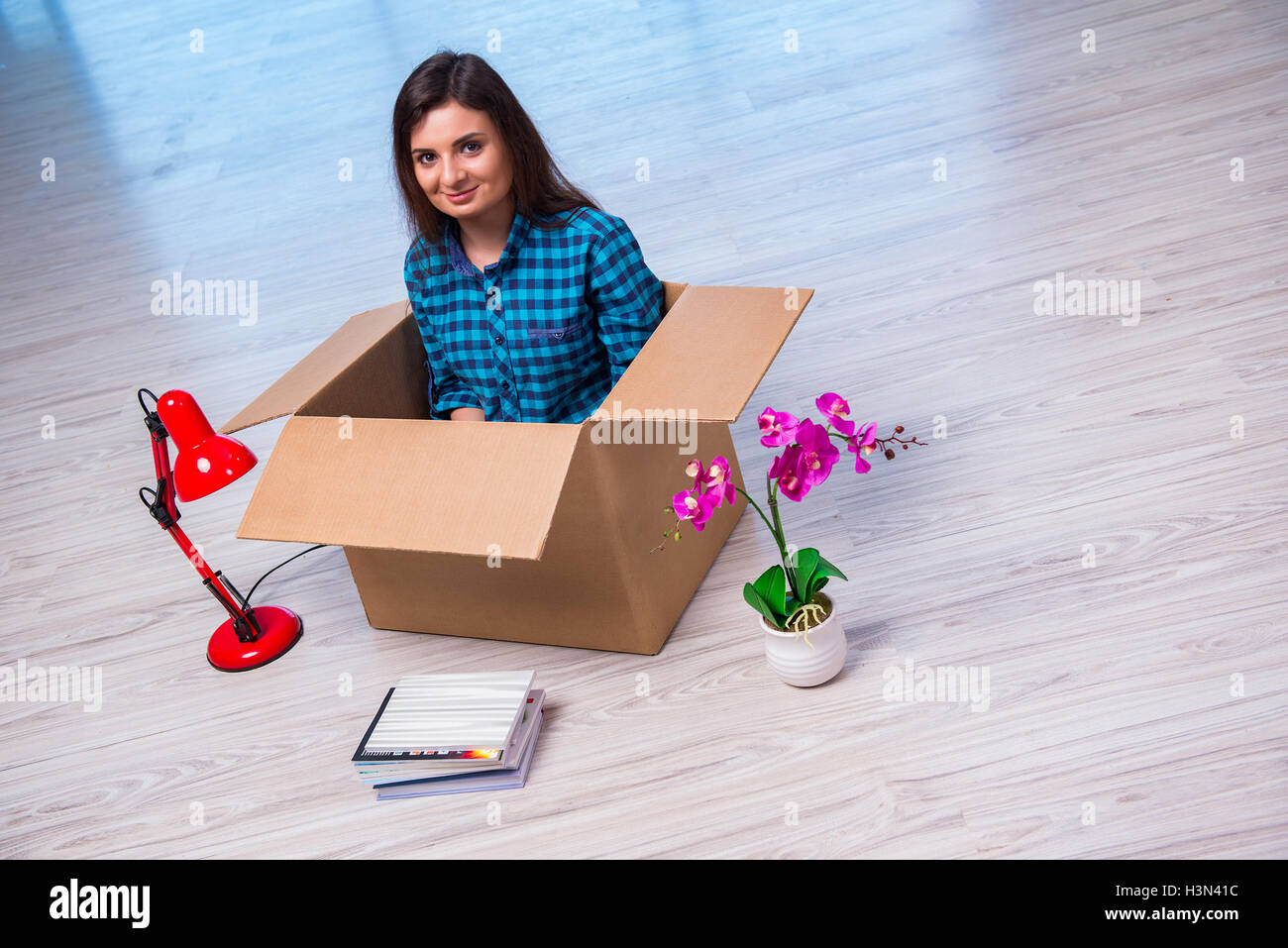 Young woman moving personal belongings Stock Photo - Alamy