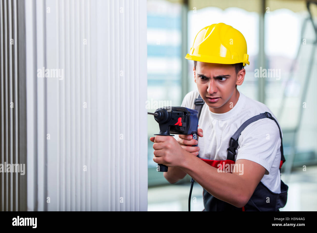 Man drilling the wall with drill perforator Stock Photo - Alamy