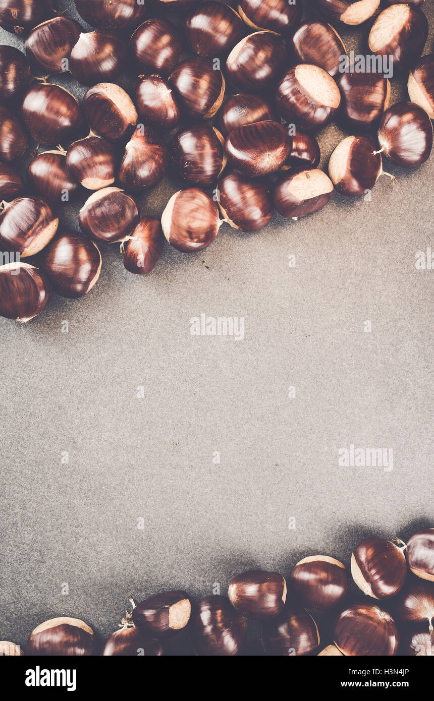ripe chestnuts on a slate background - seasonal fruits Stock Photo - Alamy