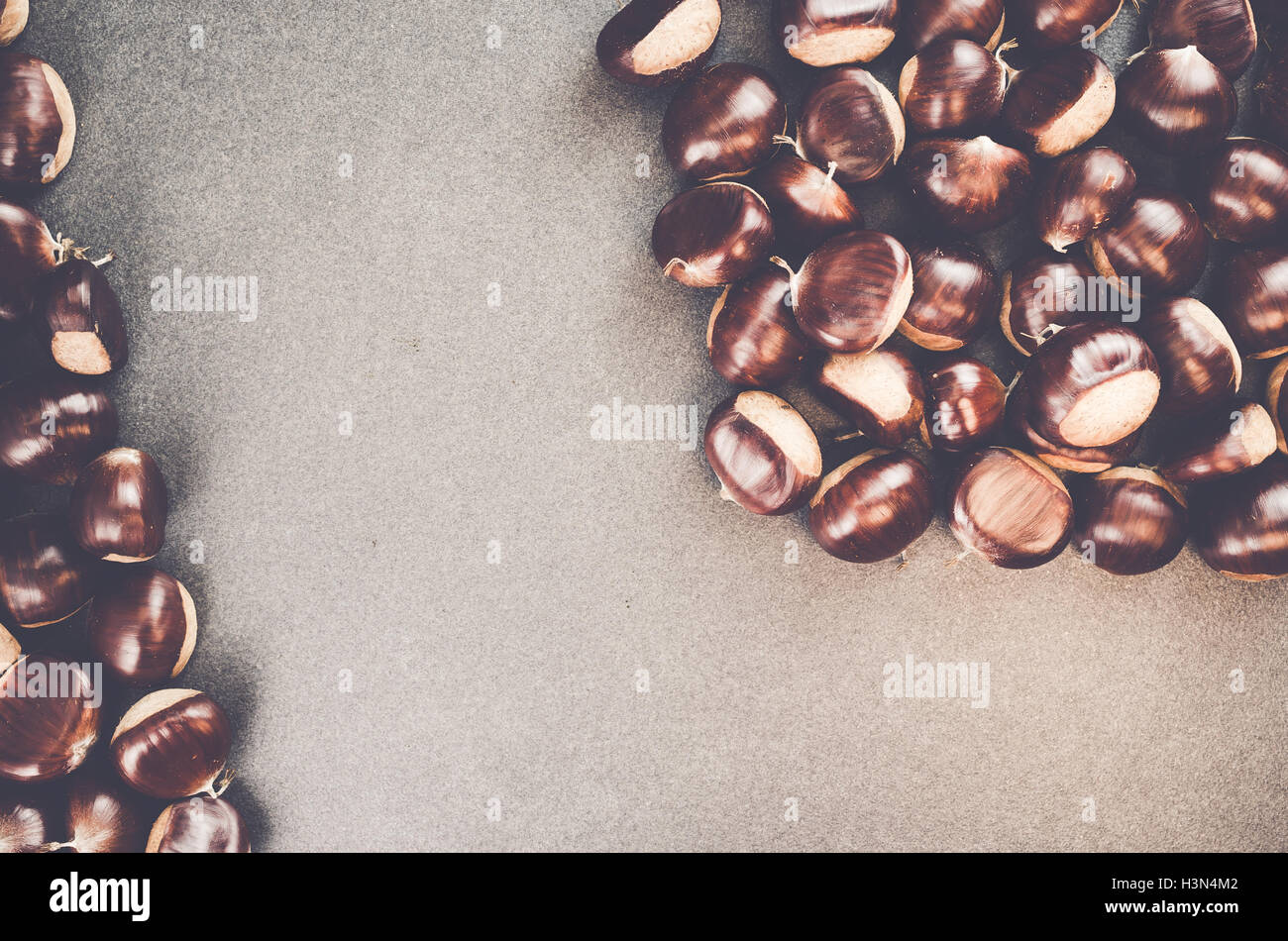 ripe chestnuts on a slate background - seasonal fruits Stock Photo - Alamy
