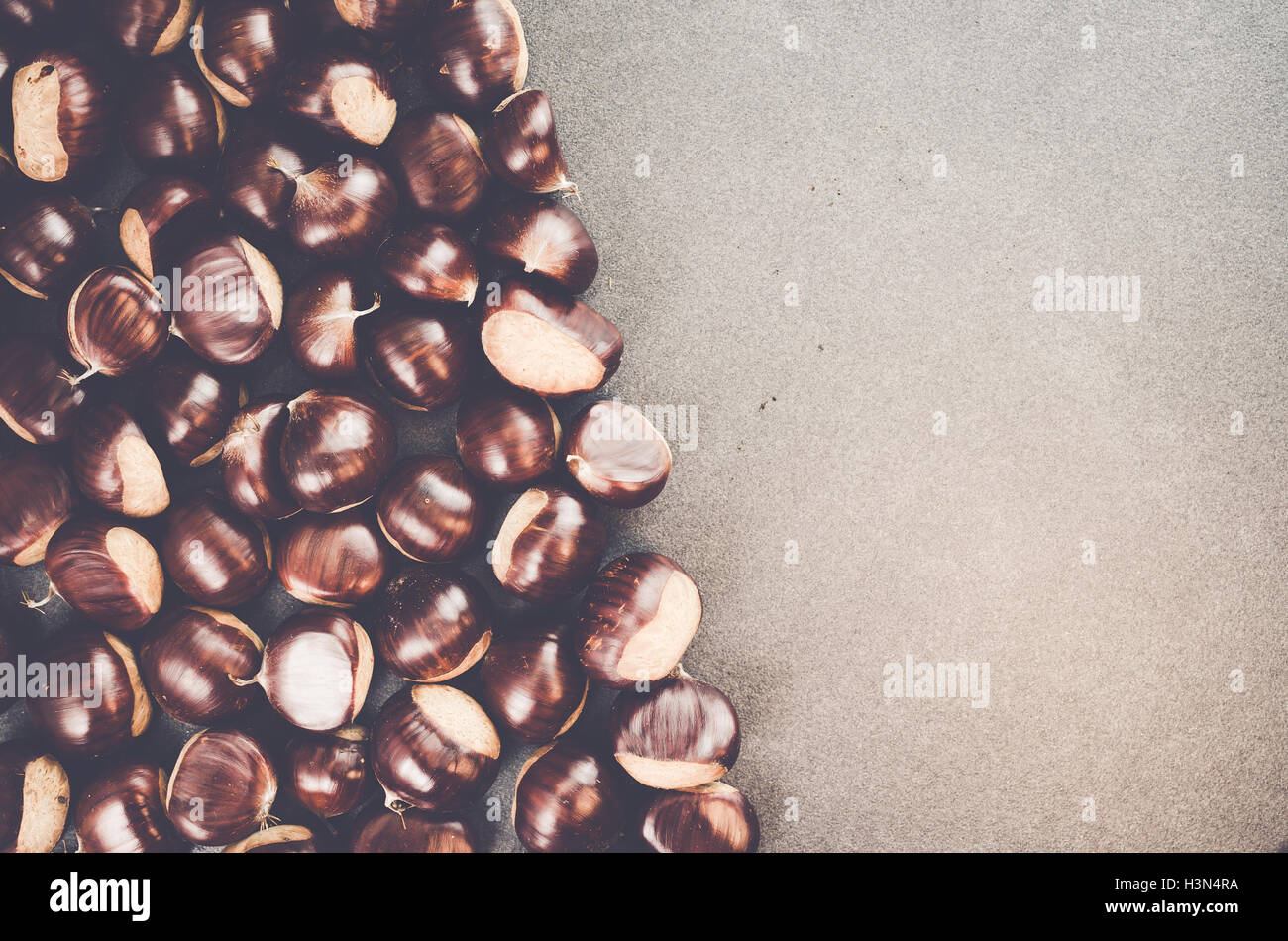 ripe chestnuts on a slate background - seasonal fruits Stock Photo - Alamy