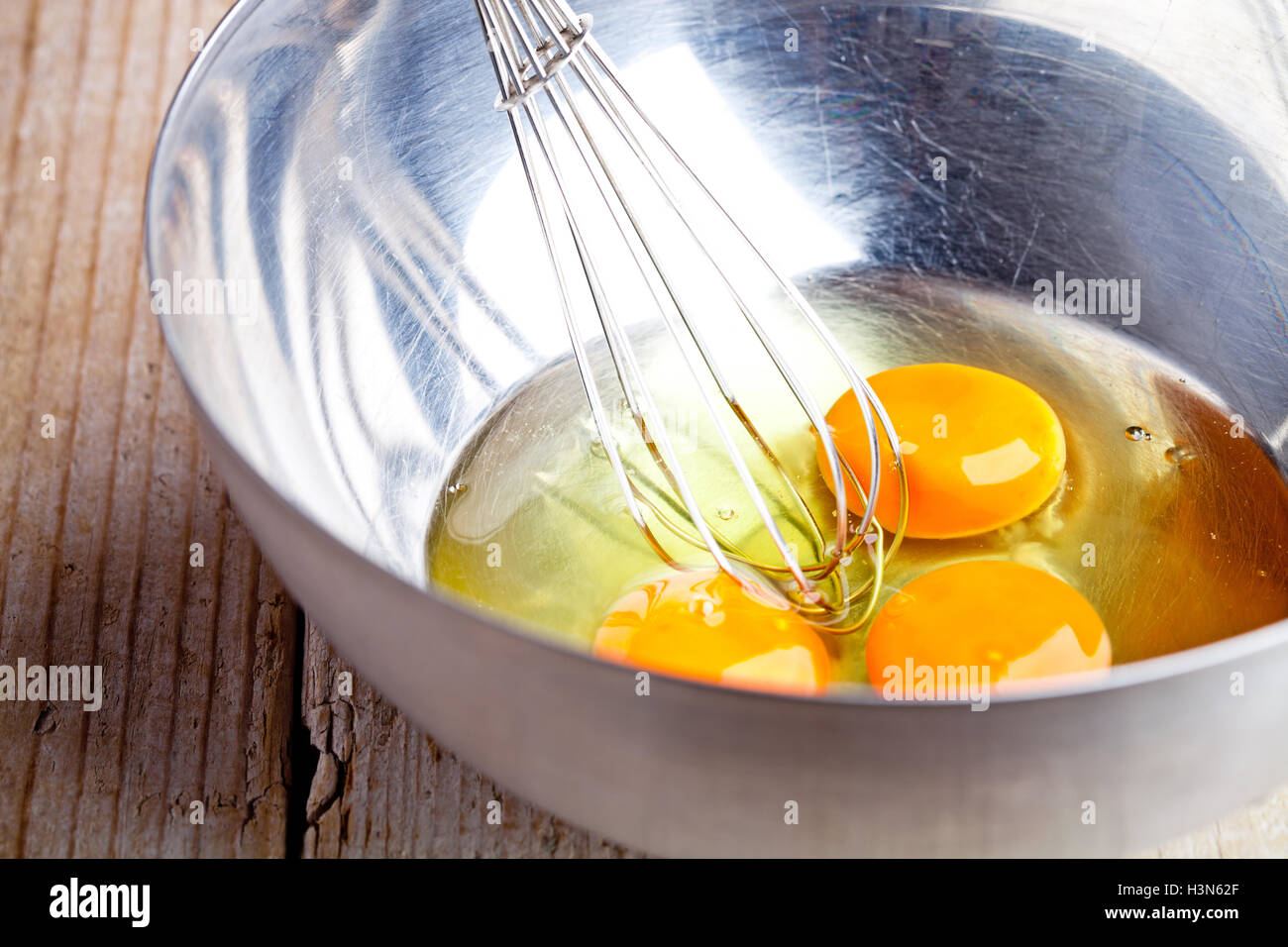 whisking eggs in metal bowl Stock Photo - Alamy