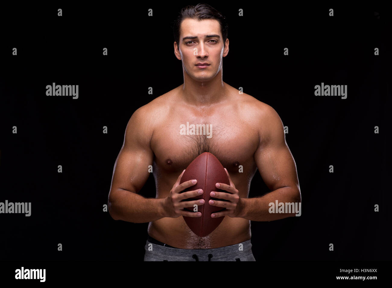 Ripped muscular man with american football Stock Photo - Alamy