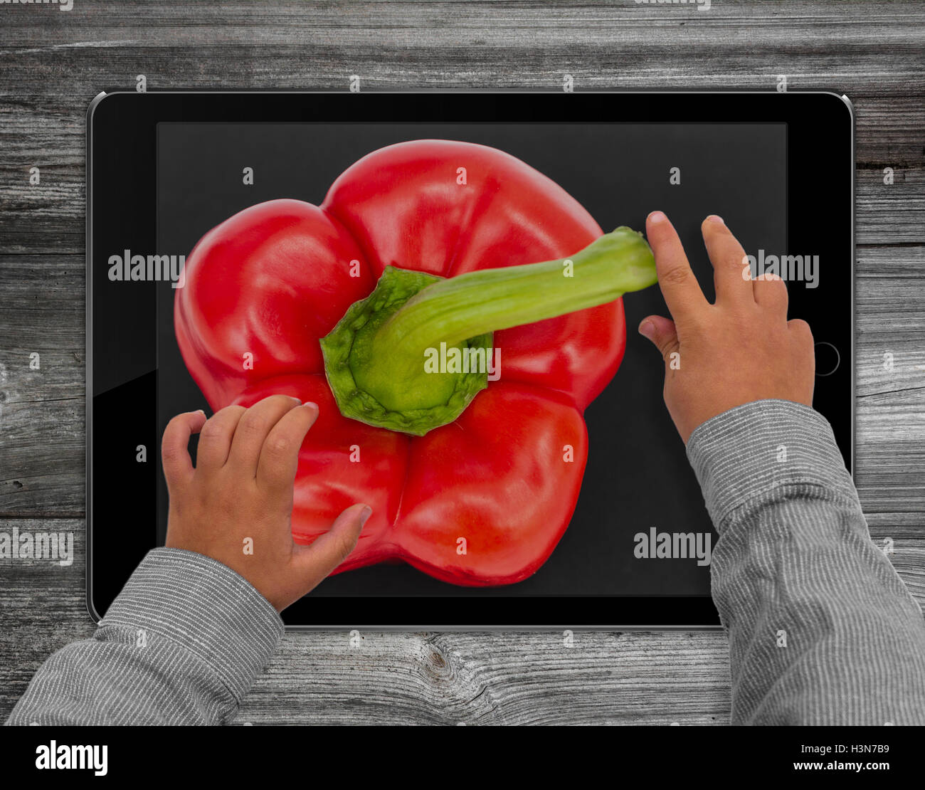 child hands on tablet computer with food picture Stock Photo - Alamy