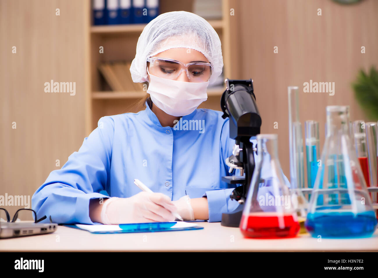 Lab chemist working with microscope and tubes Stock Photo - Alamy