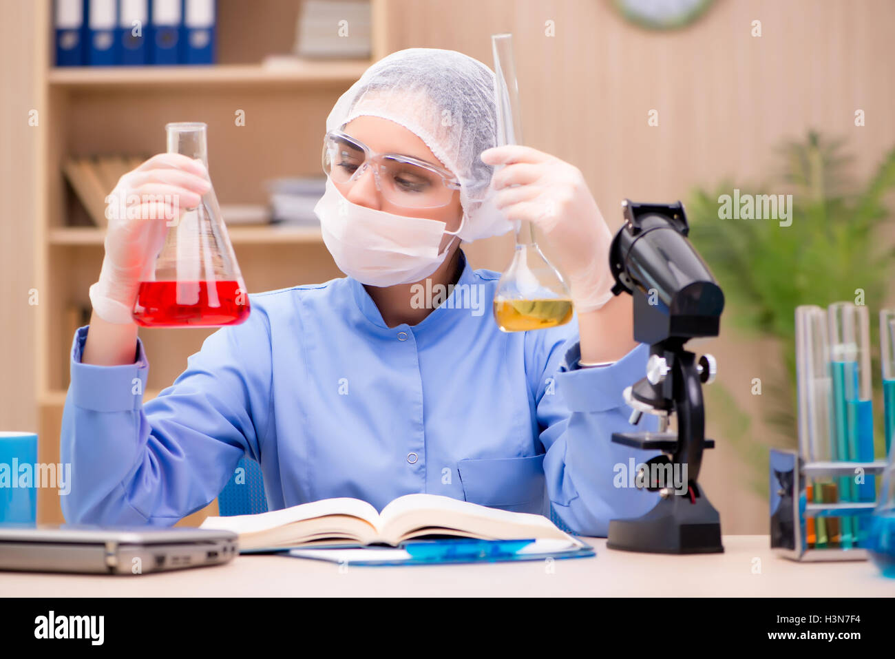 Lab chemist working with microscope and tubes Stock Photo - Alamy