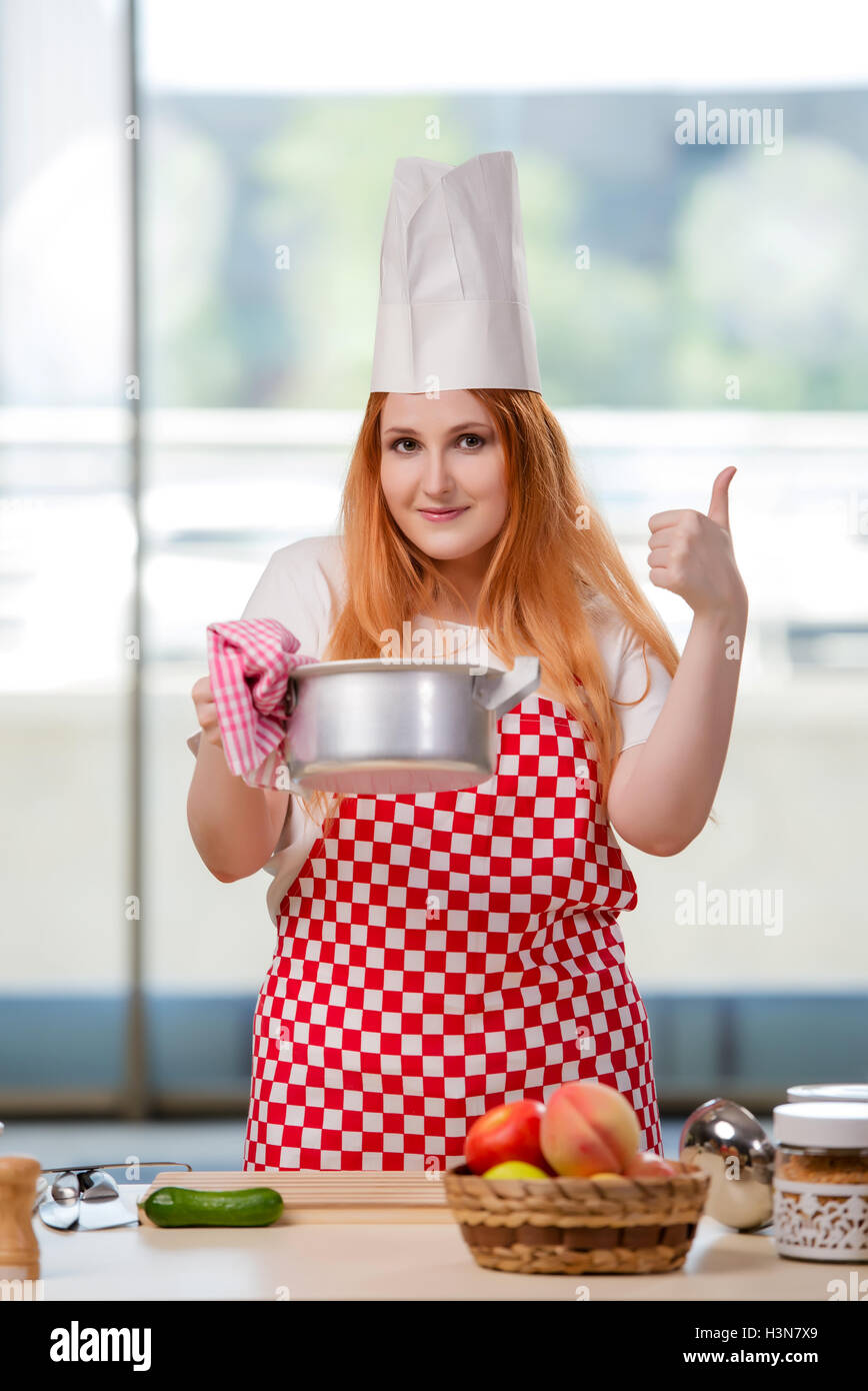 Redhead cook working in the kitchen Stock Photo - Alamy