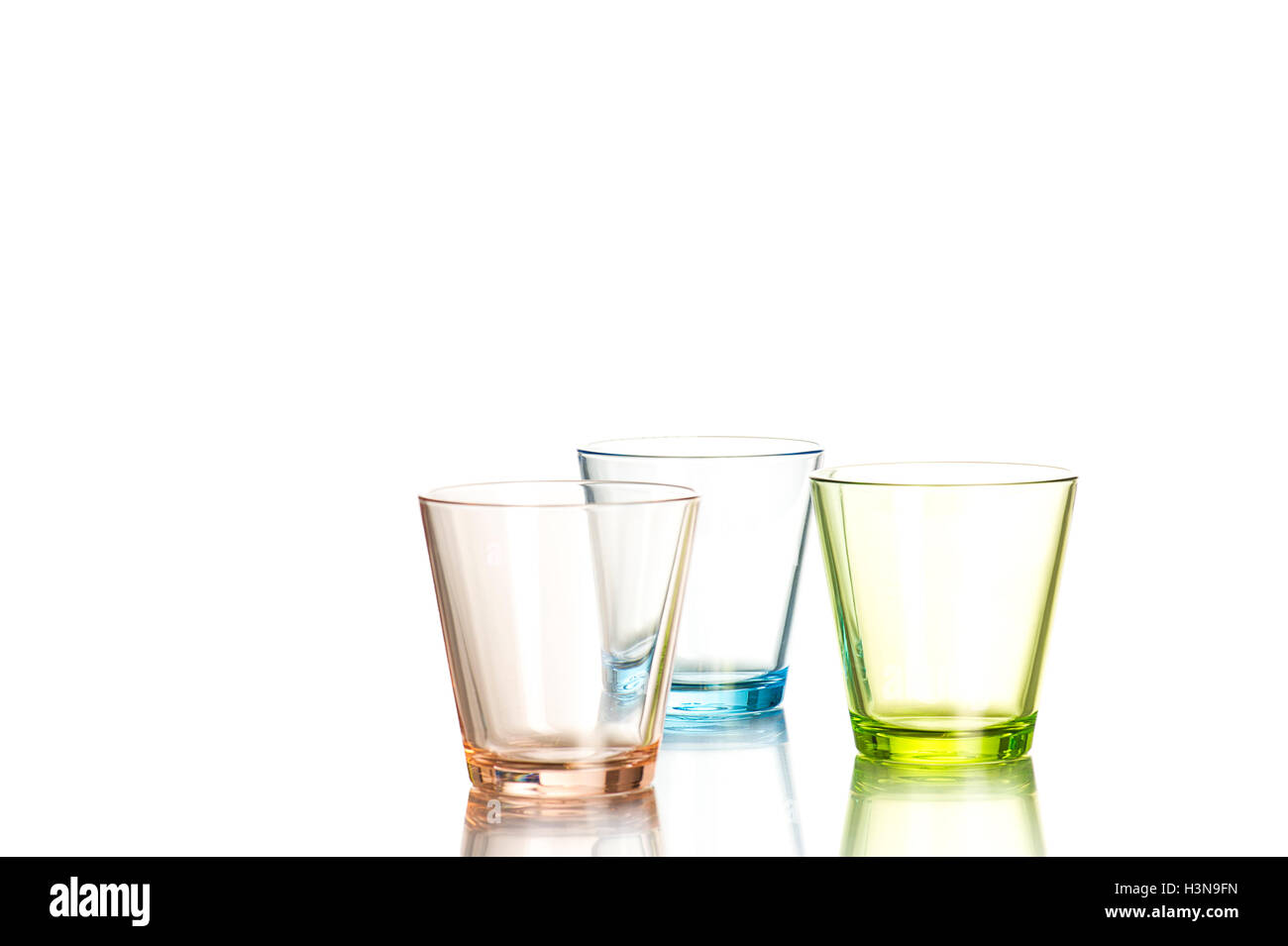 Three shot glasses on white background Stock Photo - Alamy