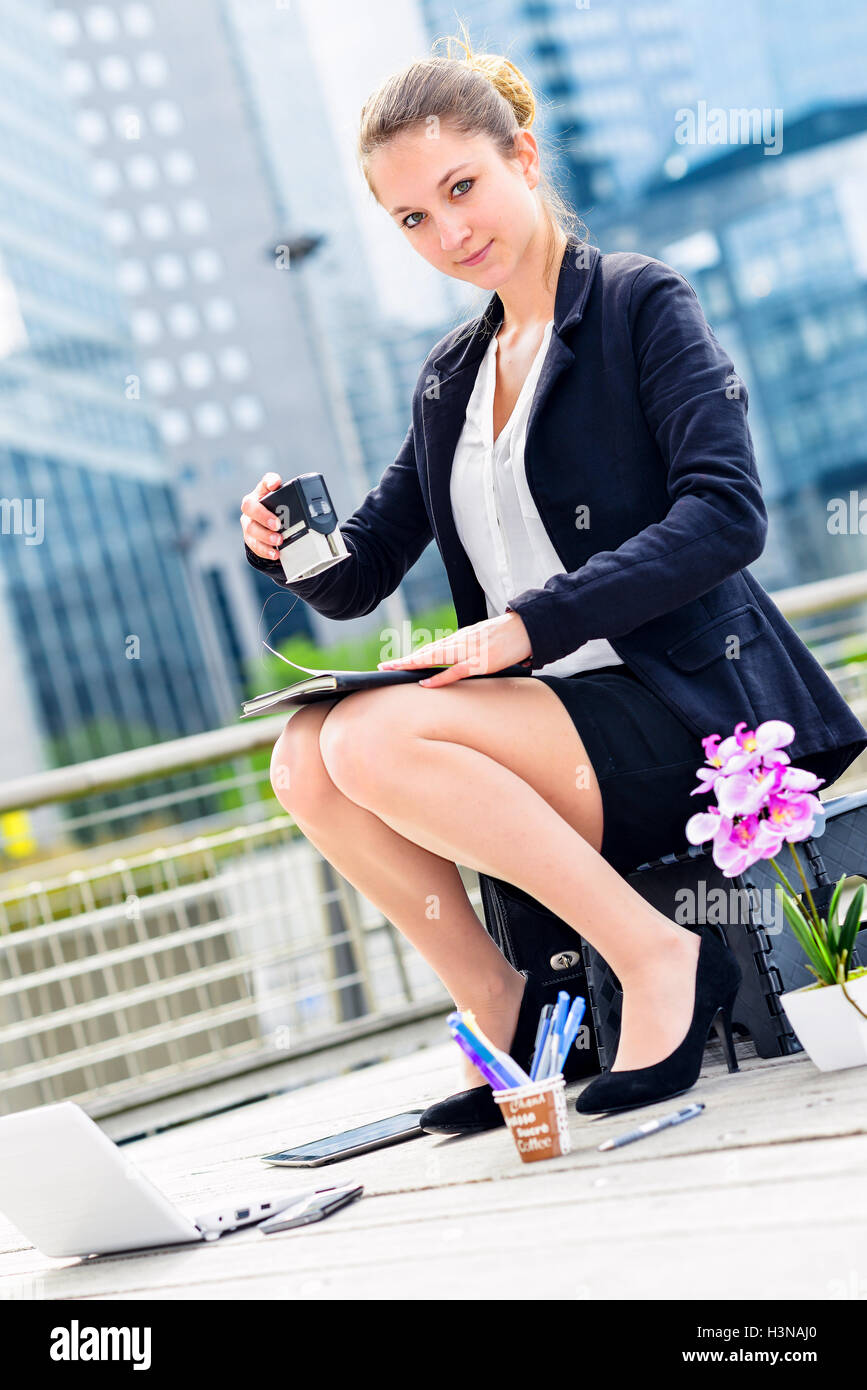 Junior executive dynamic working outside of her office Stock Photo - Alamy